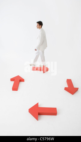 Businessman walking with arrows on the background and briefcase on his ...