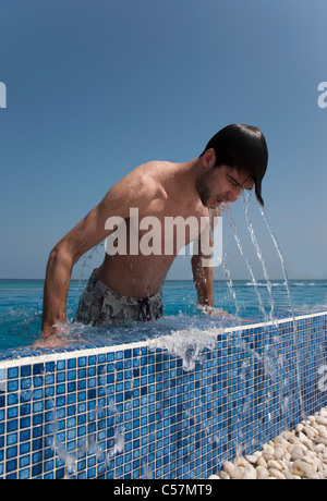 Men climbing out of swimming pool Stock Photo: 61178338 - Alamy