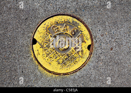 Gas utility manhole cover with yellow paint on asphalt, top view Stock ...