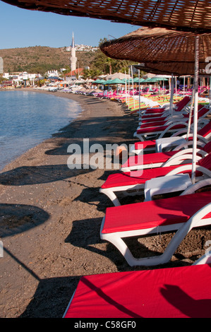 Sun loungers and colorful beach umbrellas on sandy seaside resort with ...