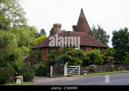 Old traditional Oast house with typical Kentish white wooden clapboard ...