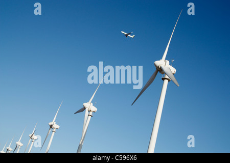 Airplane flying over wind turbines Stock Photo - Alamy
