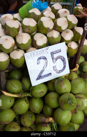 Green coconuts for sale for coconut milk at a stand on the street in ...