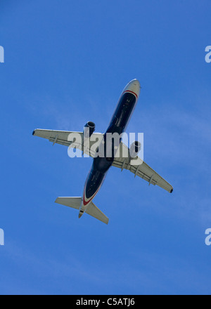 Bottom view commuter jet airplane against blue sky Stock Photo - Alamy