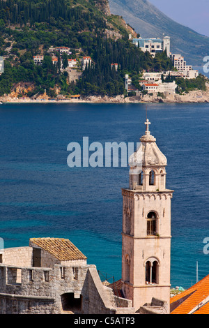 A historic walled town with a church tower sits above a horseshoe river ...