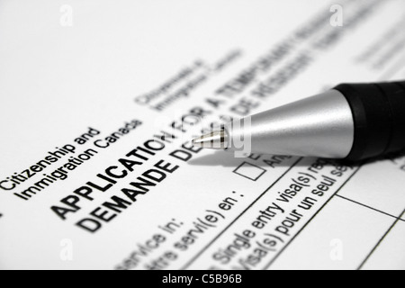 Visa application form, stamp and Canadian flag on table. Concept of ...