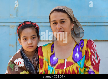 Portrait of an Uzbeki mother and child in the courtyard of the Kalon ...
