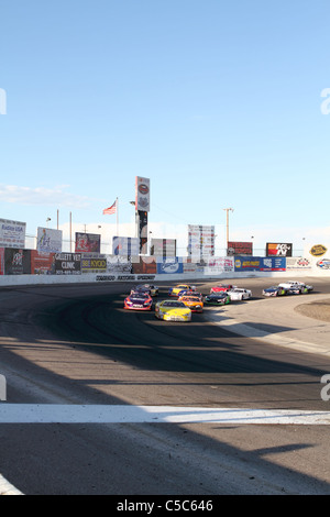 Cars round Turn 4 to start a NASCAR Cup Series auto race at Phoenix ...