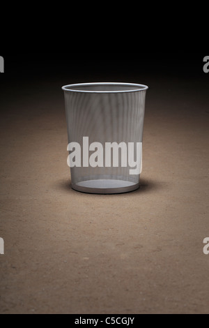 Empty wastepaper basket on dirty concrete floor Stock Photo - Alamy