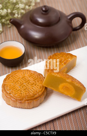 Stack of traditional moon cakes, teapot and cup prepared of mid-autumn ...