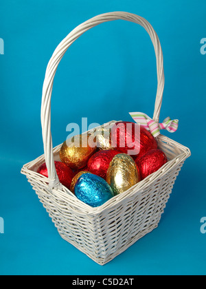 Gold egg in a basket full of eggs Stock Photo - Alamy