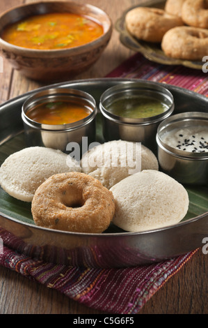 South Indian breakfast of Idli, wada with a hot spicy chutney wrapped ...