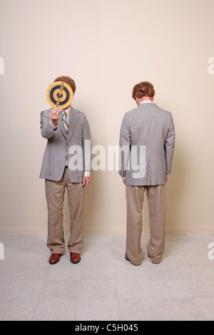 Two men standing back to back Stock Photo - Alamy