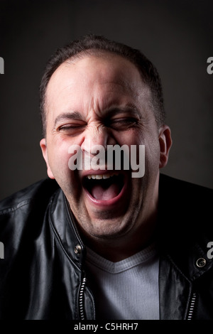 A man laughing hysterically at something hilarious with a funny ...