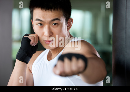 Young man punching towards the camera Stock Photo - Alamy