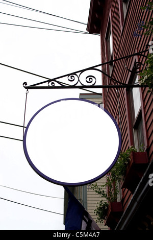 Blank old fashioned metal store sign with lantern hanging on the corner ...