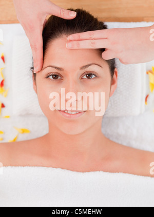 Young woman having forehead massage on spa treatment Stock Photo - Alamy