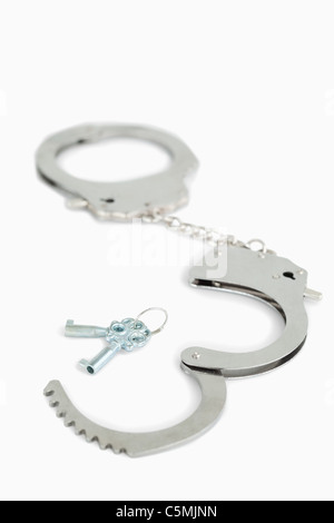 A close-up of metal handcuffs isolated on a white background Stock ...