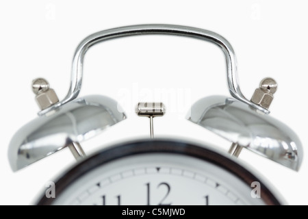 Old fashioned style alarm clock set to 8 o'clock. 8 AM is a common ...