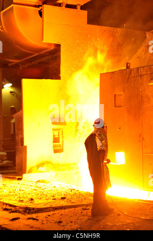 Blast furnace. Molten metal pouring from a blast furnace. This furnace ...