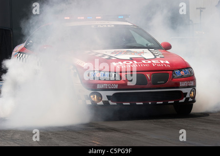 Holden Commodore performing a tire smoking burnout at a drag race ...