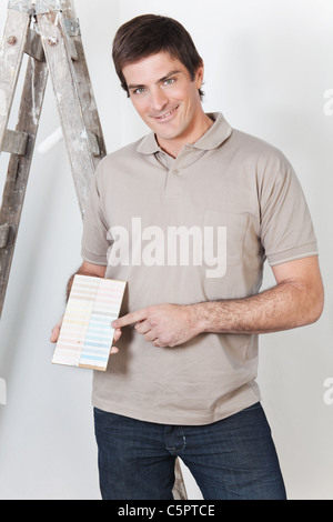 Pointing, selection and smile with portrait of man in studio for thank ...
