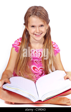 happy child reading book on bean bag chair isolated on pink Stock Photo ...