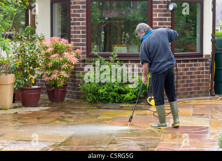 Man jet washing a patio Stock Photo - Alamy