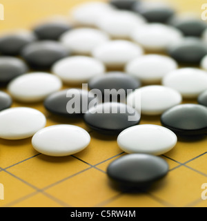 black and white go game stones and wooden bowls on goban Stock Photo ...