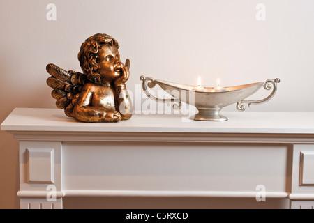 Angel figurine and decoration on shelf Stock Photo - Alamy