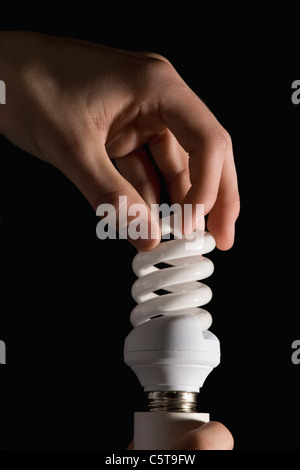 hand holding an energy-saving lamp Stock Photo - Alamy