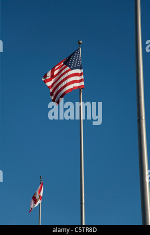 The American flag flies against a clear blue sky, vertical. Freedom and ...