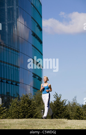Germany, Berlin, Young woman jogging in city Stock Photo - Alamy