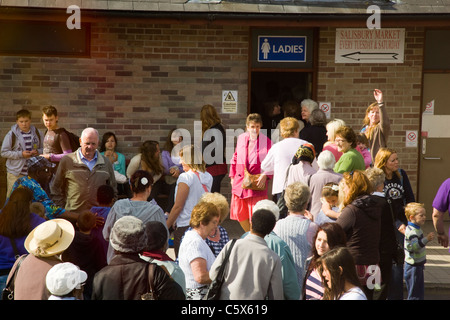 Crowds and long queue outside a ladies toilet in a service station ...