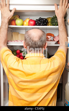 Man Looking Inside Fridge Full Of Unhealthy Food Stock Photo - Alamy