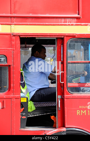 London bus driver at work right hand drive steering wheel interior cab ...