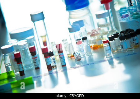 glass test tubes with colored tops on bench side in science laboratory ...