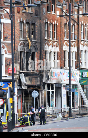 London Riots Clapham Junction burnt out shop rioting looting fire clean ...