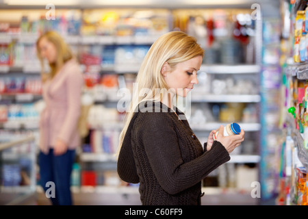 A shopper comparing two products Stock Photo - Alamy