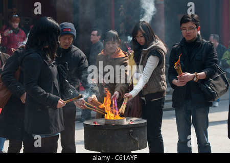Buddhist Followers Lighting Incense Sticks for Prayer in the Jade ...