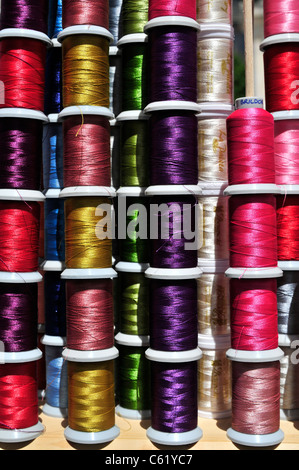 Stacked Spools of Colorful Thread on a White Background Stock Photo - Alamy