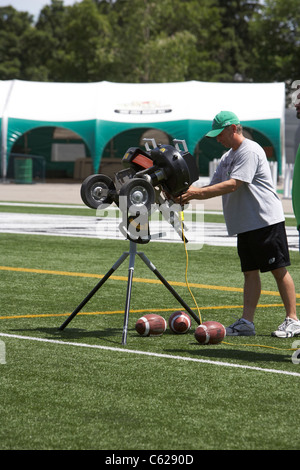trainer uses automatic football passing machine during saskatchewan ...