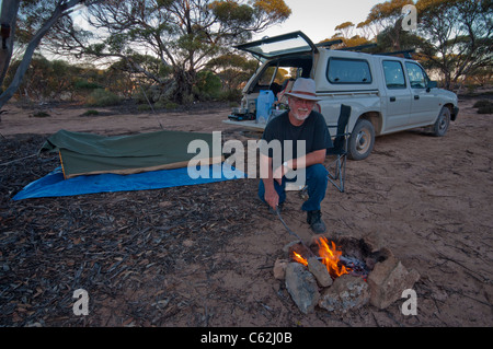 Man with campfire and pitched swag in the Australian outback Stock ...