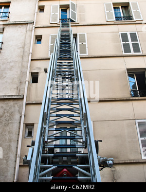 the ladder of the fire engine is extended to the window from which ...