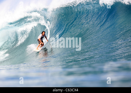 Surfer riding a large wave at Scar reef in West Sumbawa, Indonesia ...