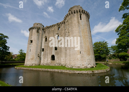 The ruins of Nunney Castle, built in the 1370s, and Nunney Brook near ...