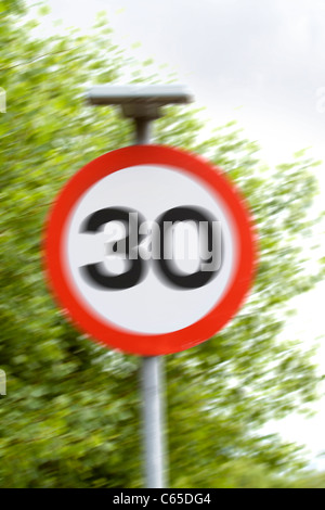 30mph maximum speed limit sign on a road in a small town in the UK ...