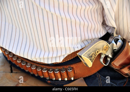 Traditional Colt-style single action revolvers in holsters at a fast ...