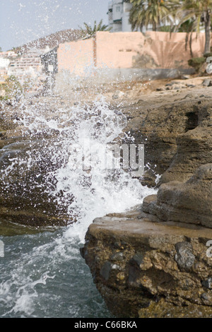 Waves splashing in sea against sky Stock Photo - Alamy