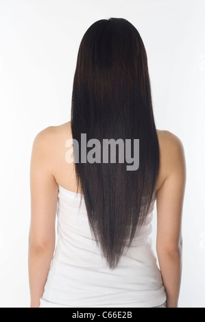 Woman with long hair back view on blue background Stock Photo - Alamy